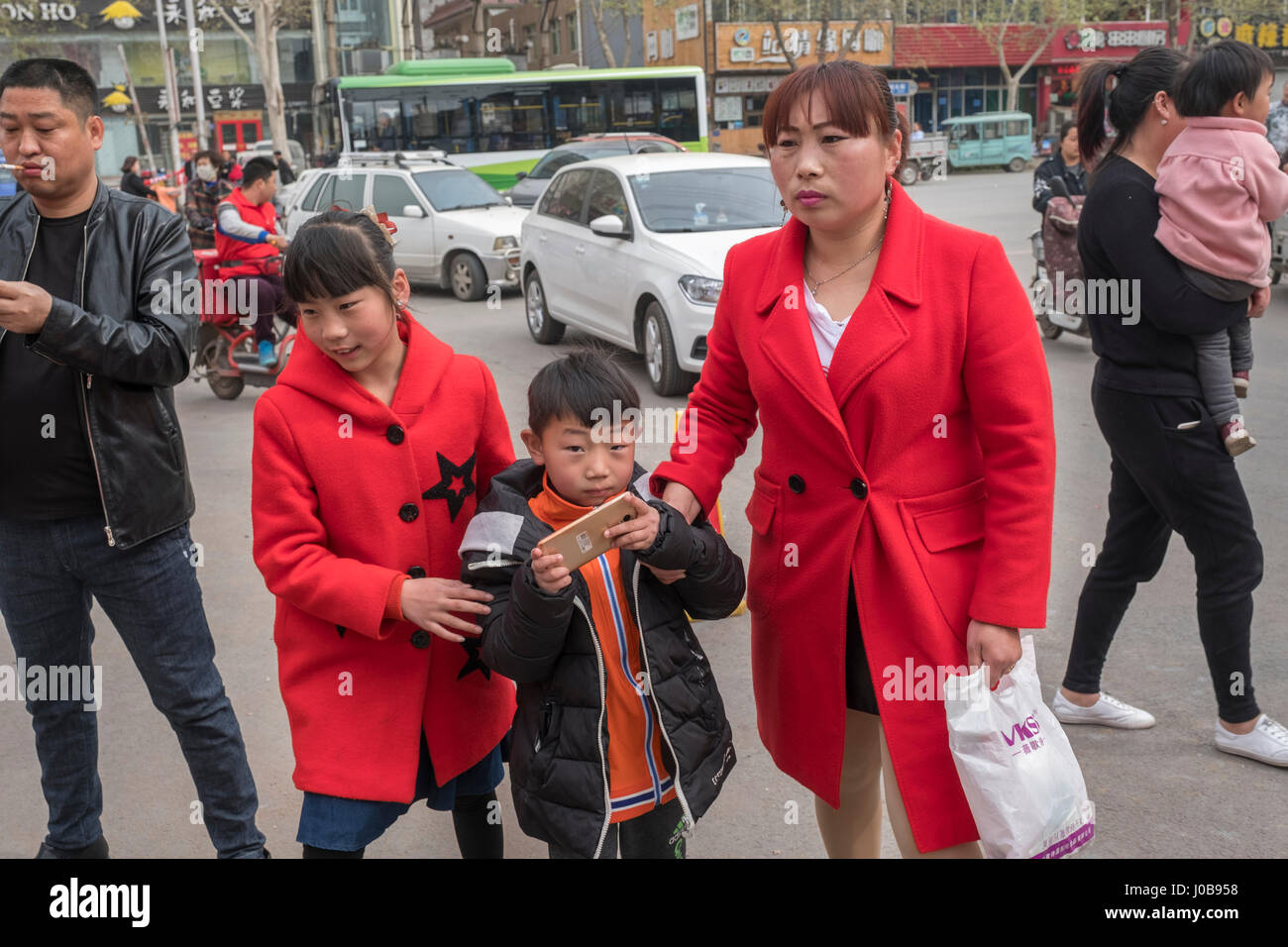 A mother with two children, one girl and one boy, in Xiong County ...