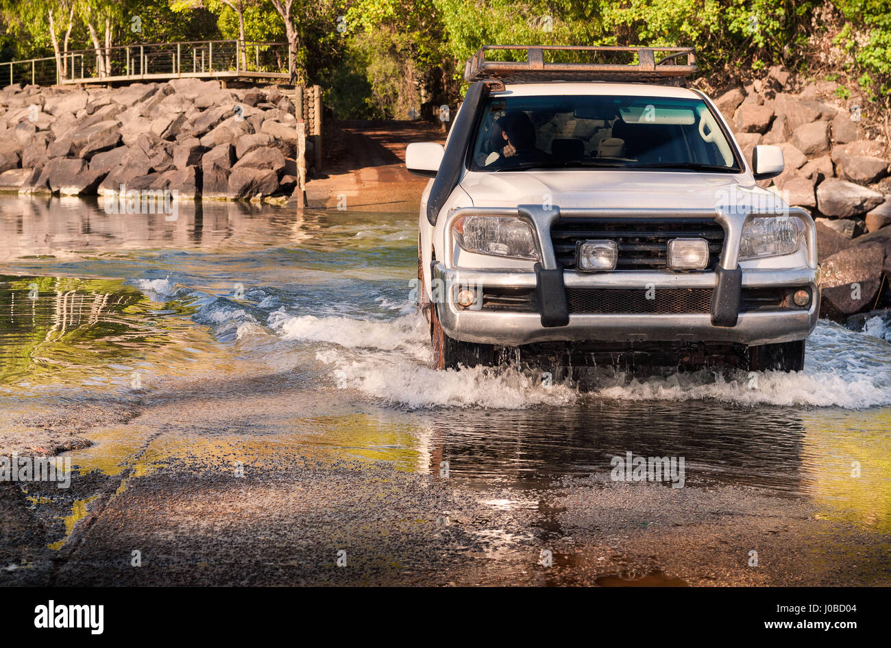 Off-road vehicle driving across a river. East Alligator Northern ...