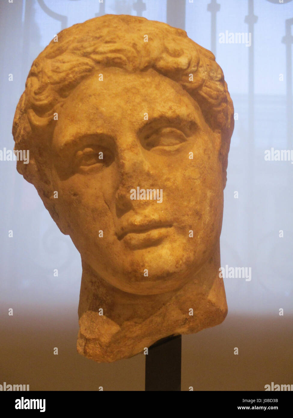 This artwork is a head sculpture from the Hellenistic period, displayed ...