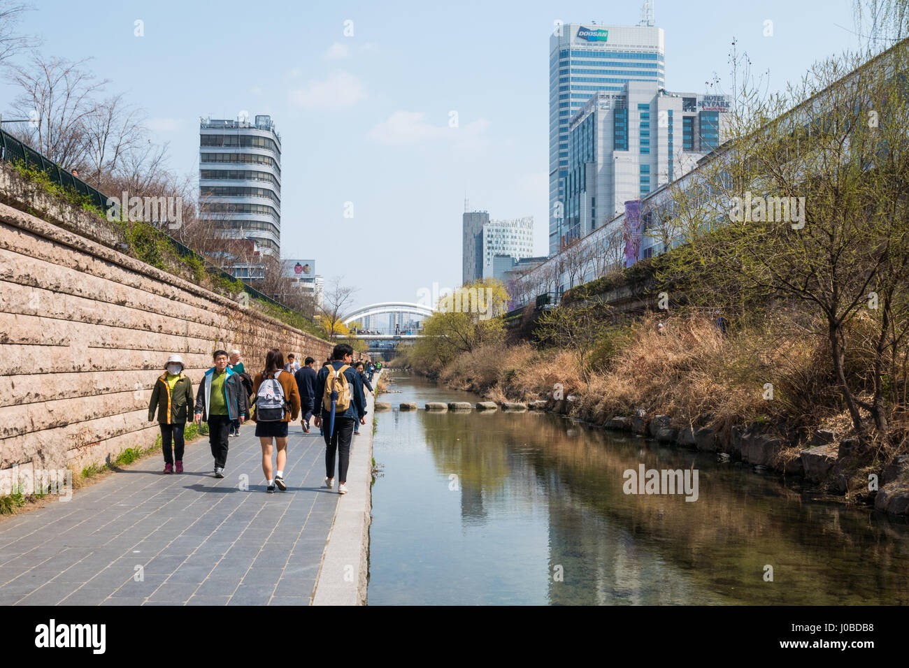 Locals and tourists enjoy a walk at Cheonggye Stream near Dongdaemun ...
