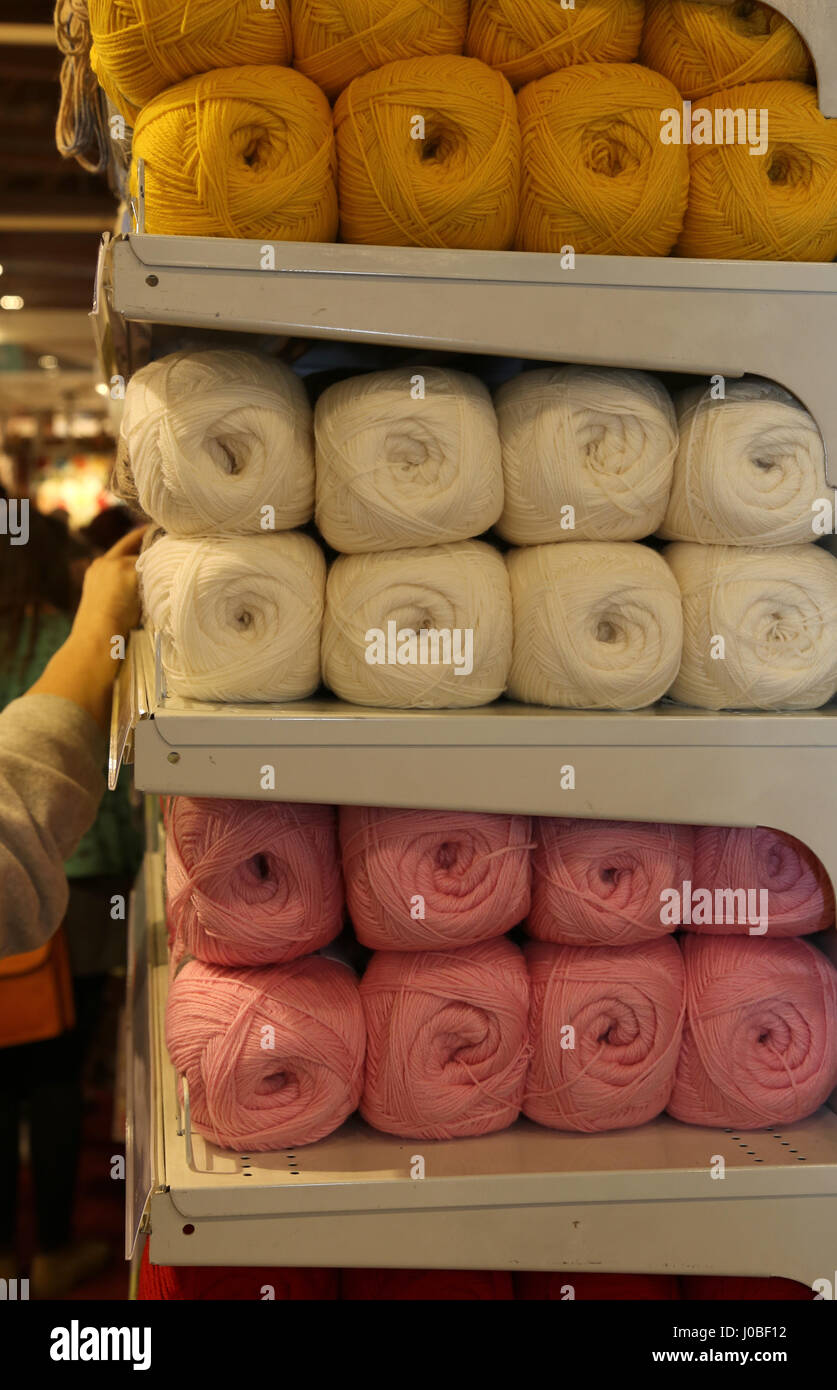 many balls of wool on the store shelf for hobbyists and seamstresses ...