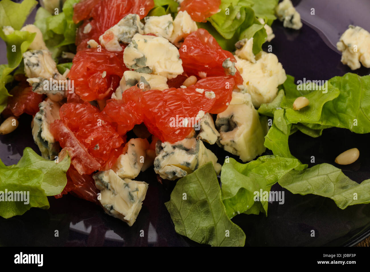 Grapefruit and blue cheese salad with cedar nut Stock Photo - Alamy