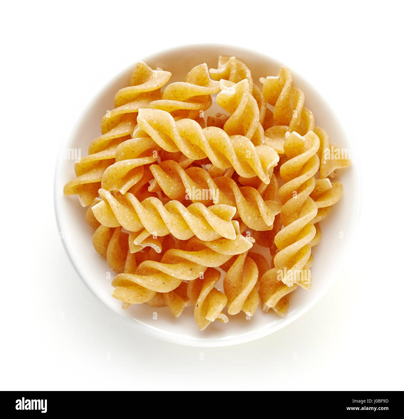 spiral pasta in bowl, isolated on white background, top view Stock ...