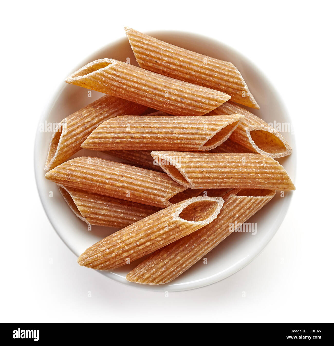Full grain penne pasta in bowl, isolated on white background, top view ...
