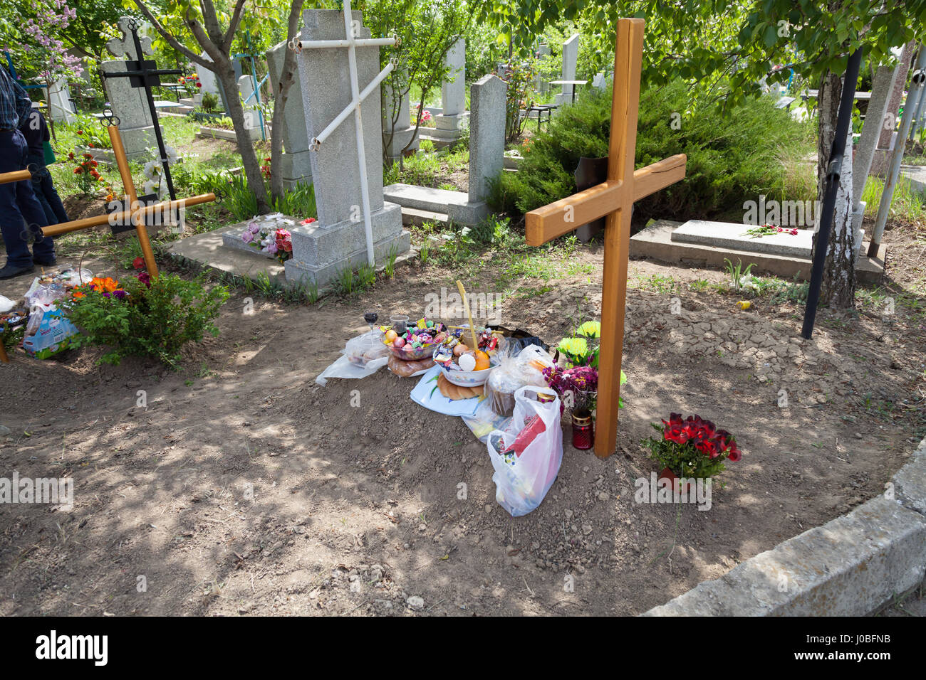 CHISINAU, MOLDOVA: A pomana, food offering left on top of a grave ...