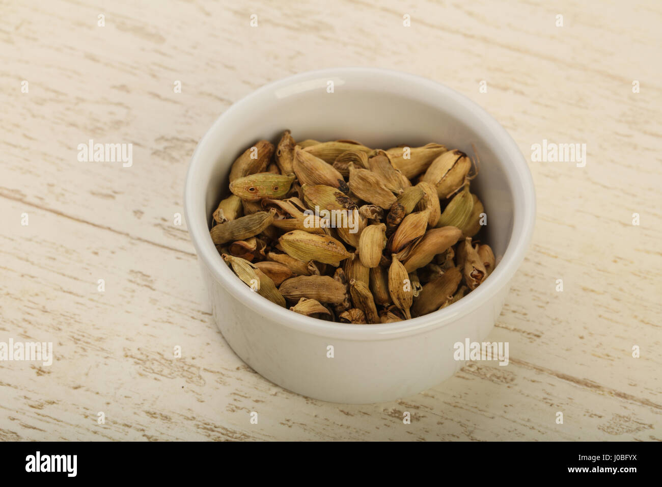 Dry cardamom seeds heap in the bowl Stock Photo - Alamy