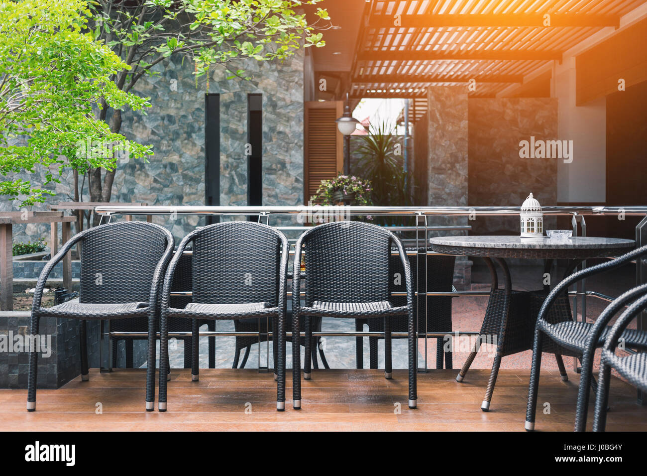 Smoking corner decorated by black furniture set on wooden floor terrace ...