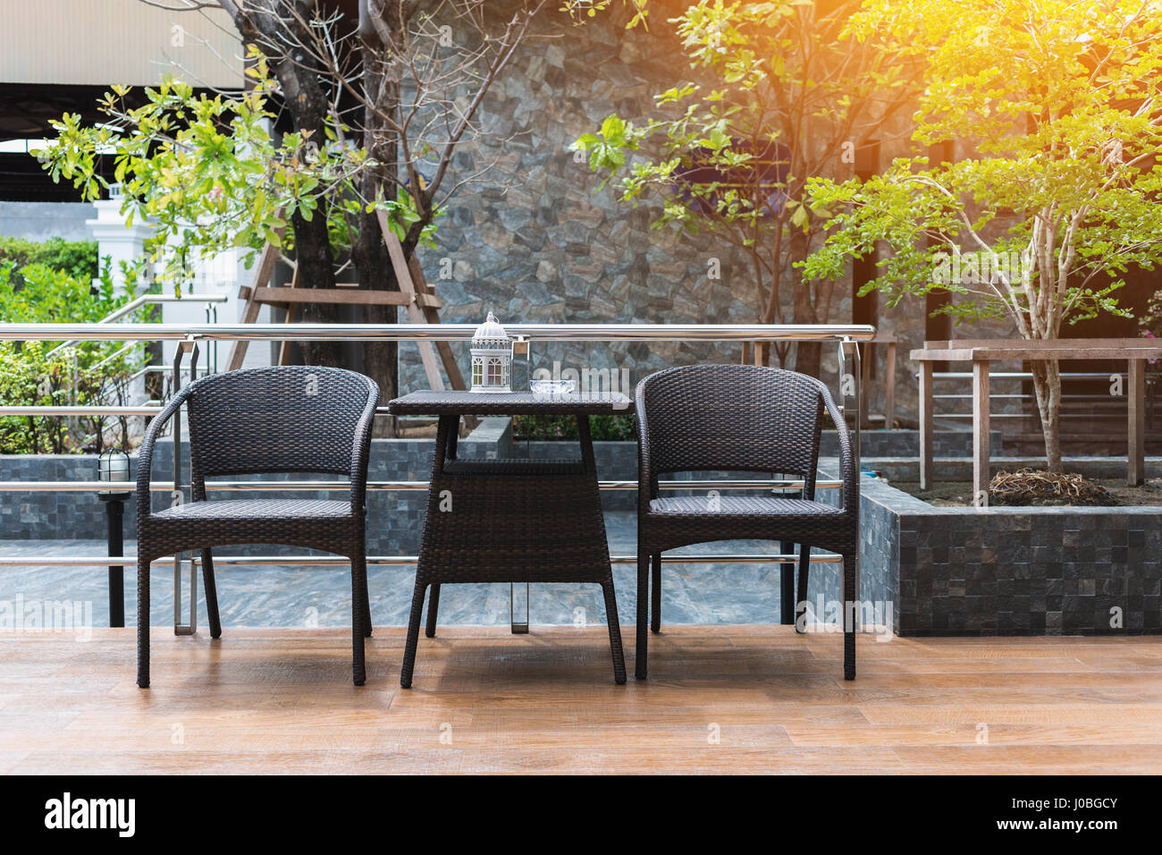 Smoking corner decorated by black furniture set on wooden floor terrace ...