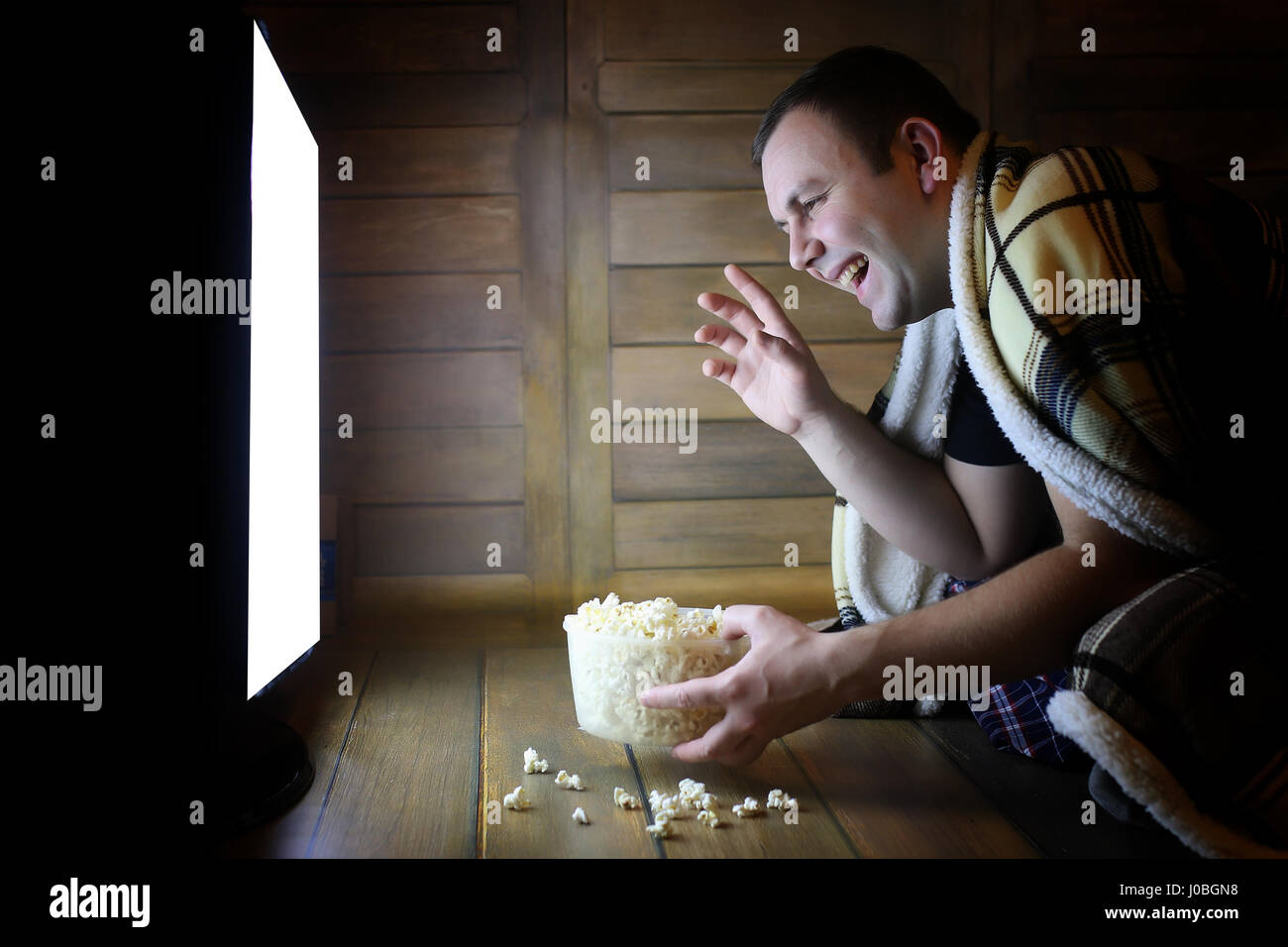 young man watching television at home on the floor Stock Photo - Alamy