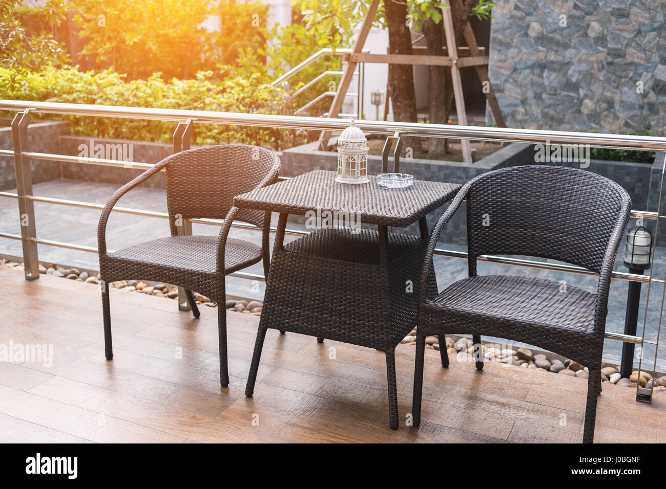 Smoking corner decorated by black furniture set on wooden floor terrace ...