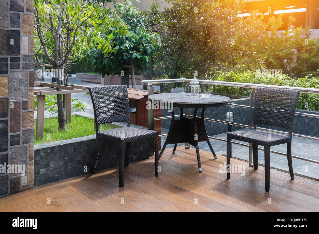 Smoking corner decorated by black furniture set on terrace wooden floor ...