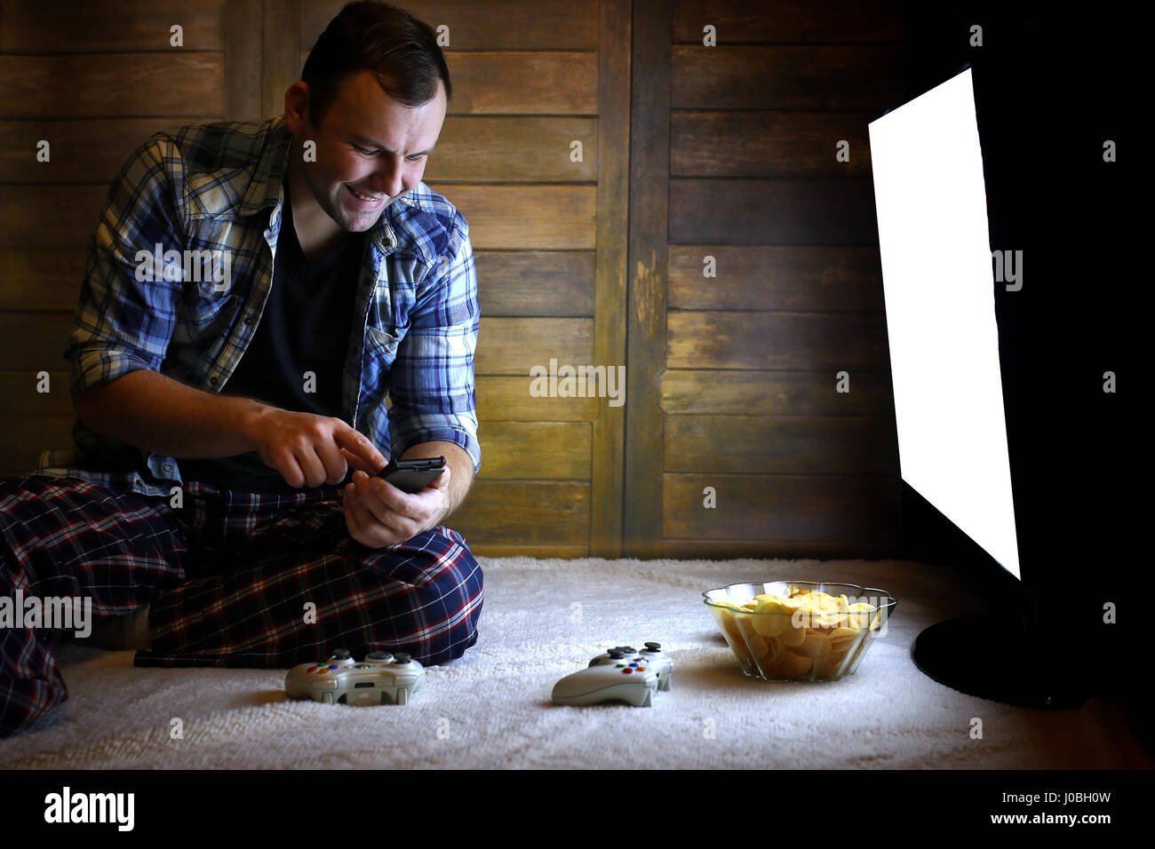 man playing on a console on the joystick before the big TV Stock Photo ...