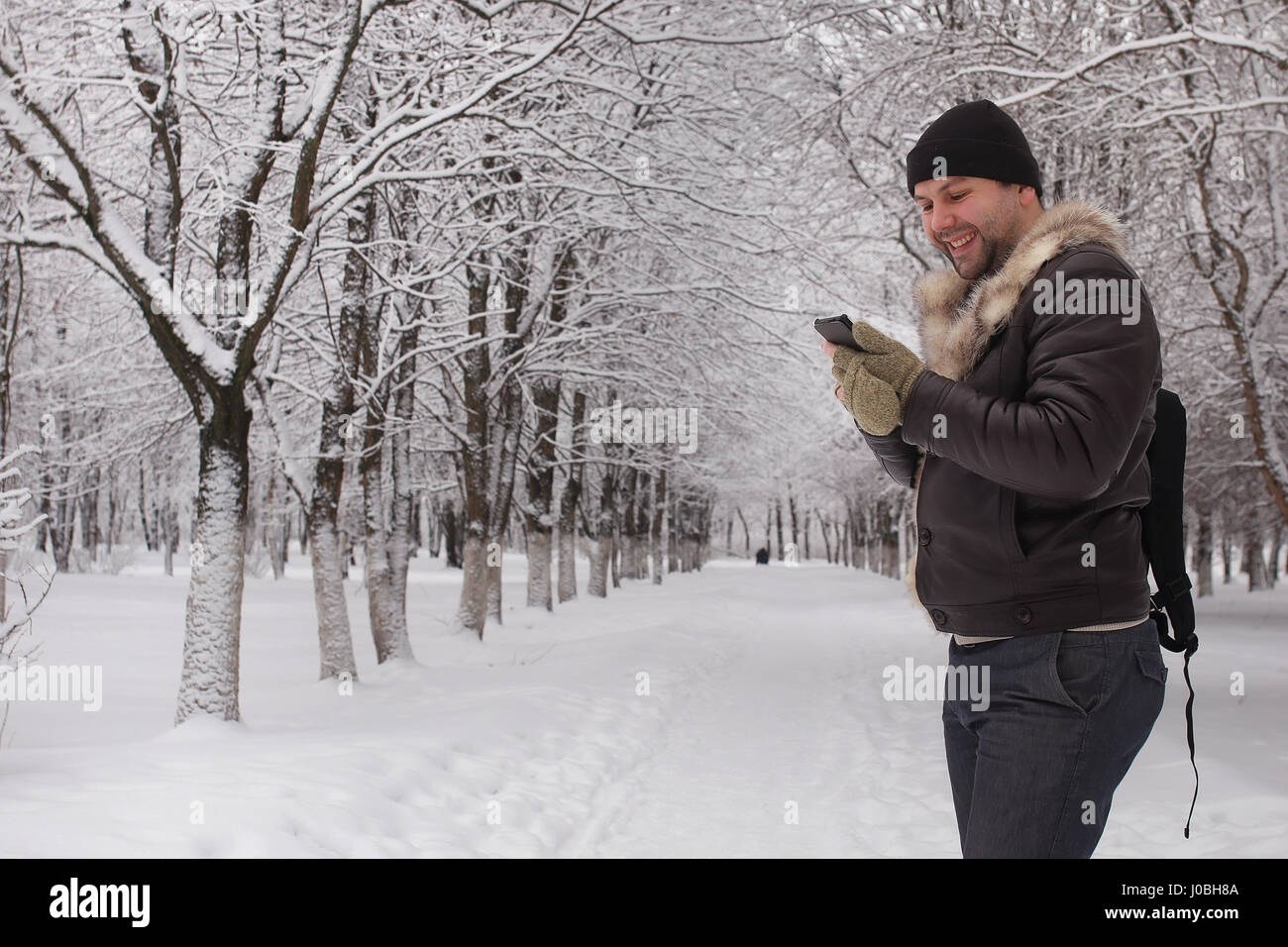 bearded man walking in a winter park Stock Photo - Alamy