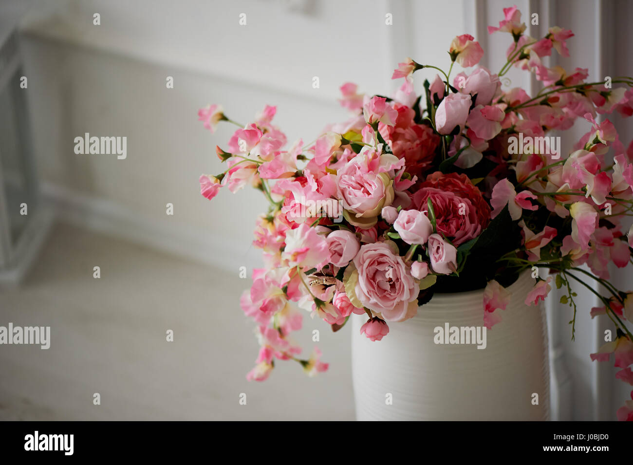 Artificial spray roses pink pastel colors are in a white vase Stock ...