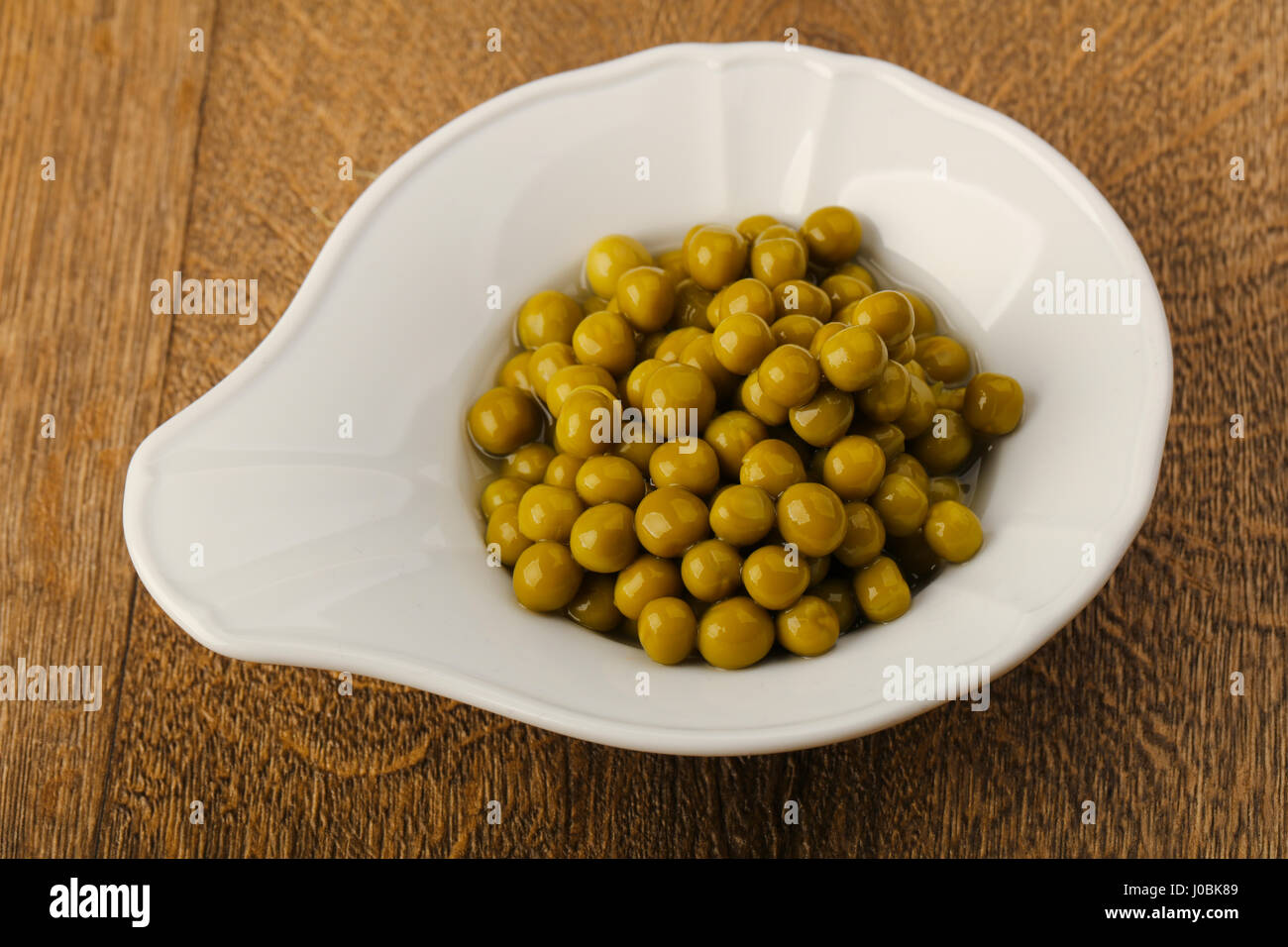 Pickled green pea on the wood background Stock Photo - Alamy