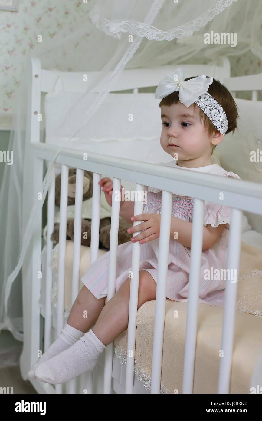 little kid sit in cot Stock Photo - Alamy