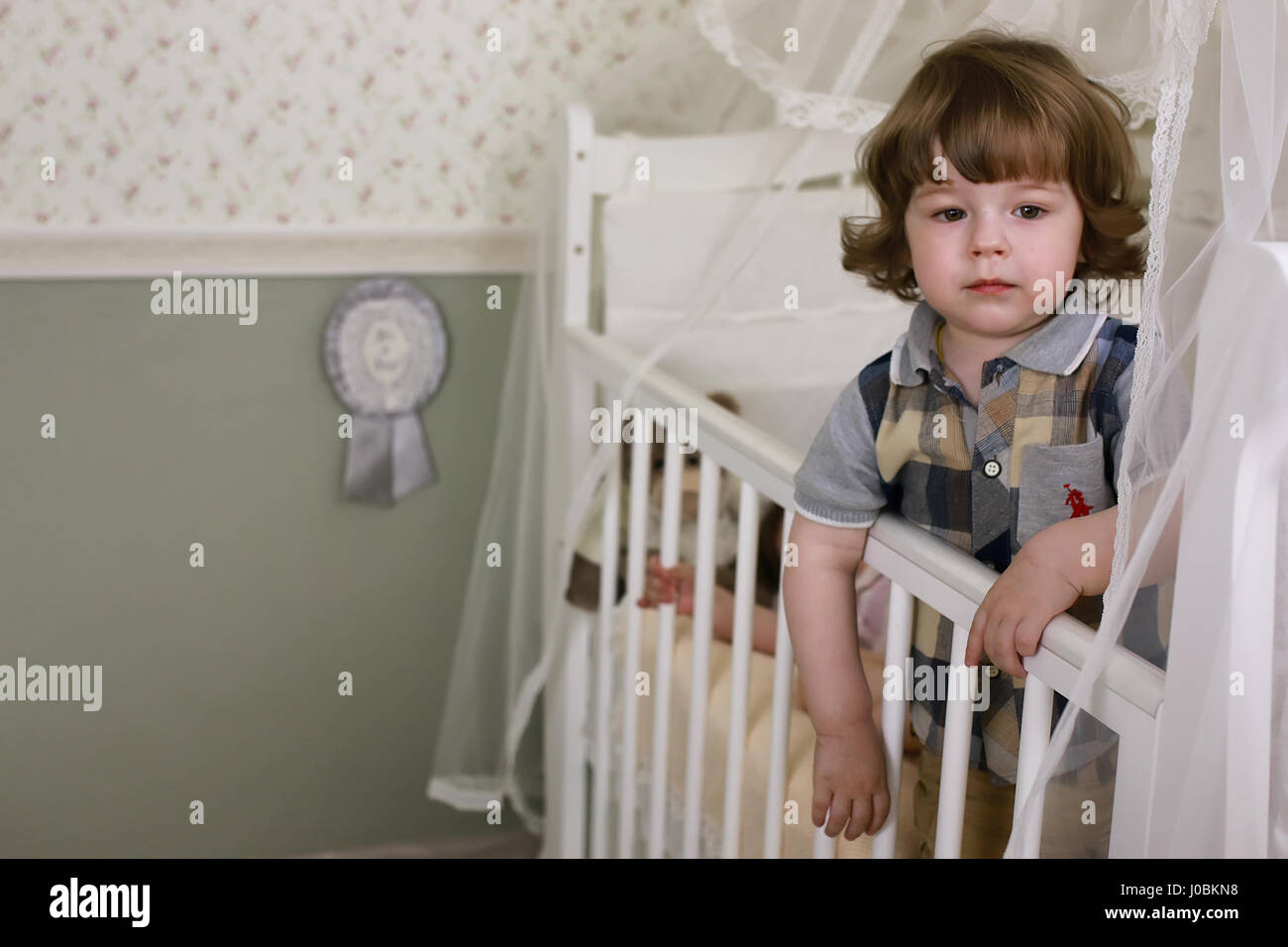 little kid sit in cot Stock Photo - Alamy