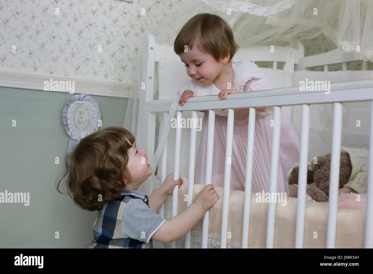 little kid sit in cot Stock Photo - Alamy