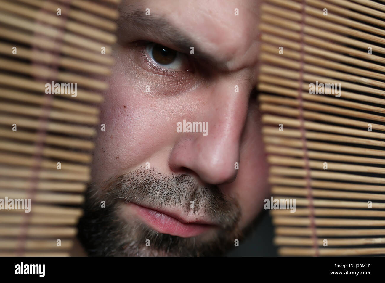 angry man at the jalousie Stock Photo - Alamy