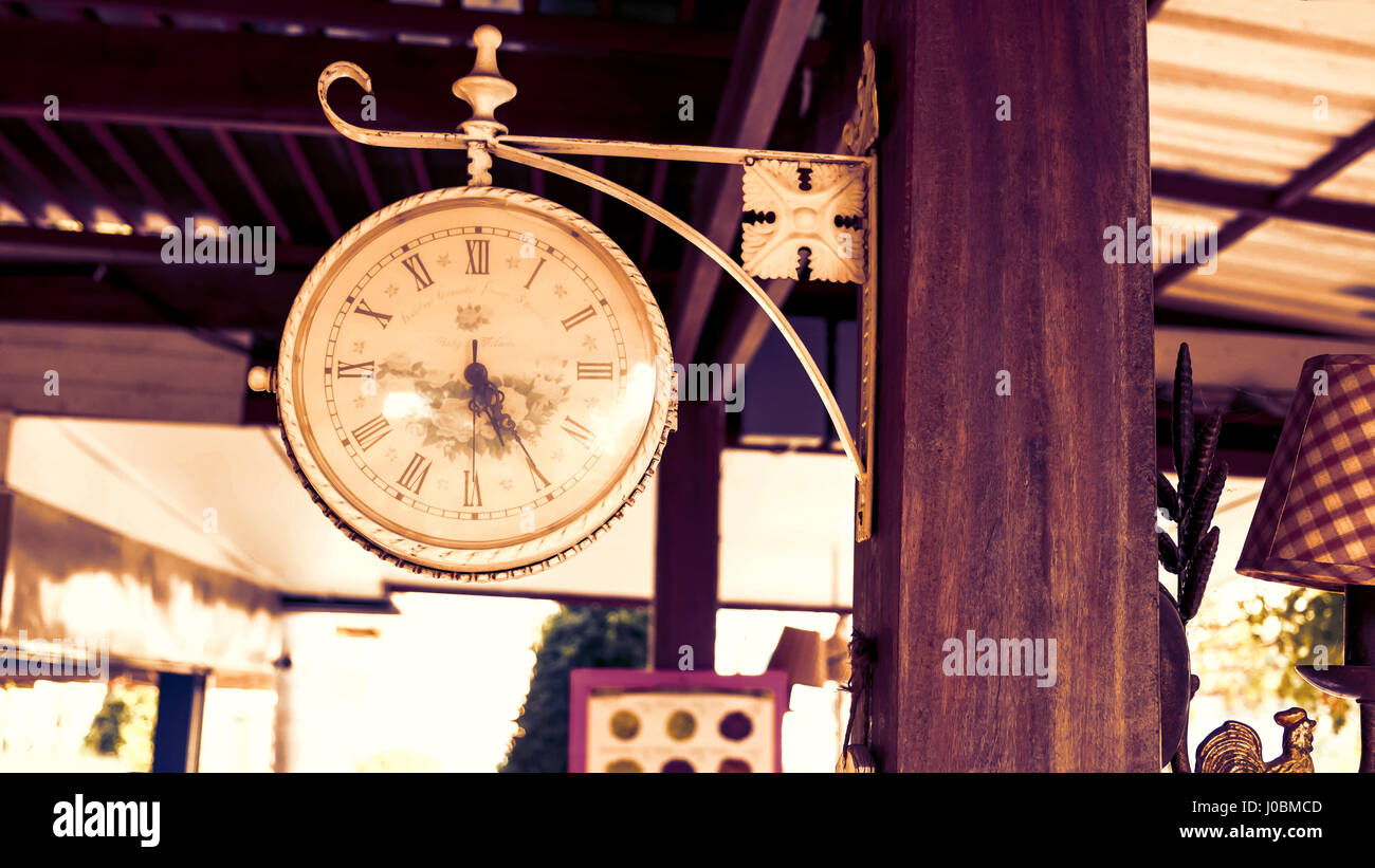 Vintage clock clamp with wooden pole Stock Photo - Alamy