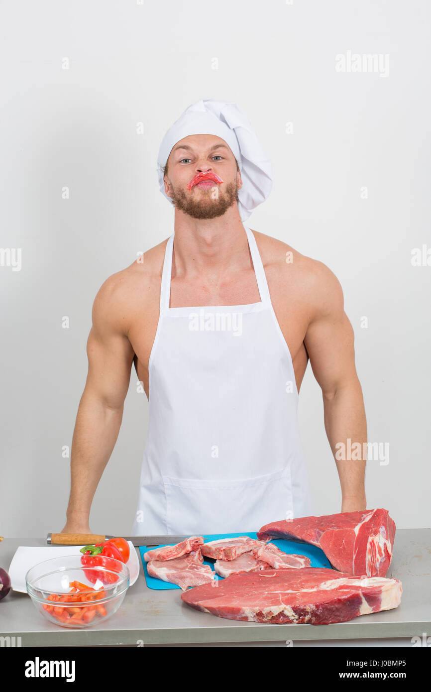 chef bodybuilder preparing large chunks of raw meat. natural proteins ...