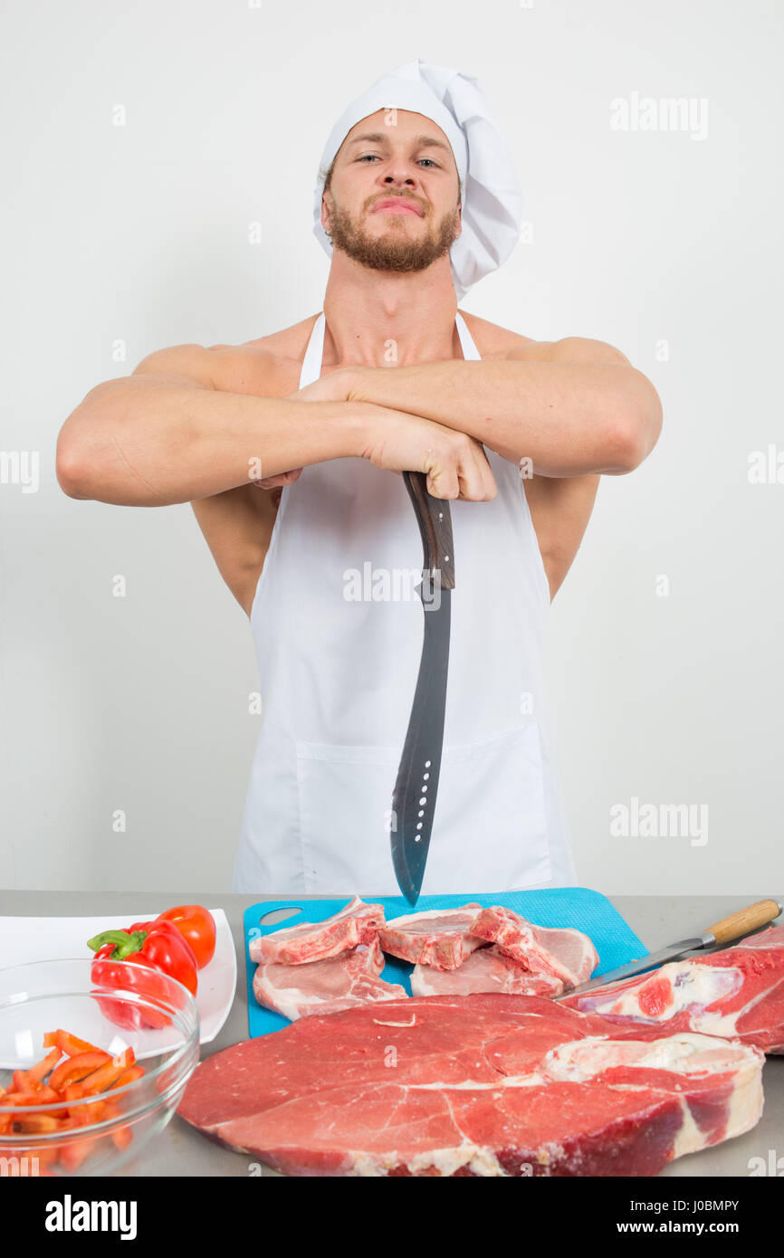 chef bodybuilder preparing large chunks of raw meat. natural proteins ...