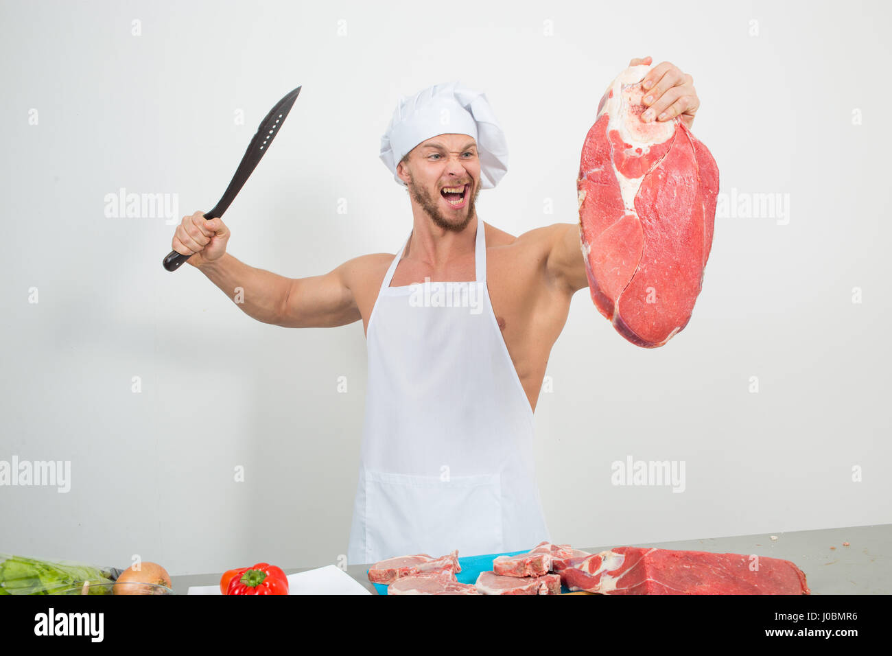 chef bodybuilder preparing large chunks of raw meat. natural proteins ...