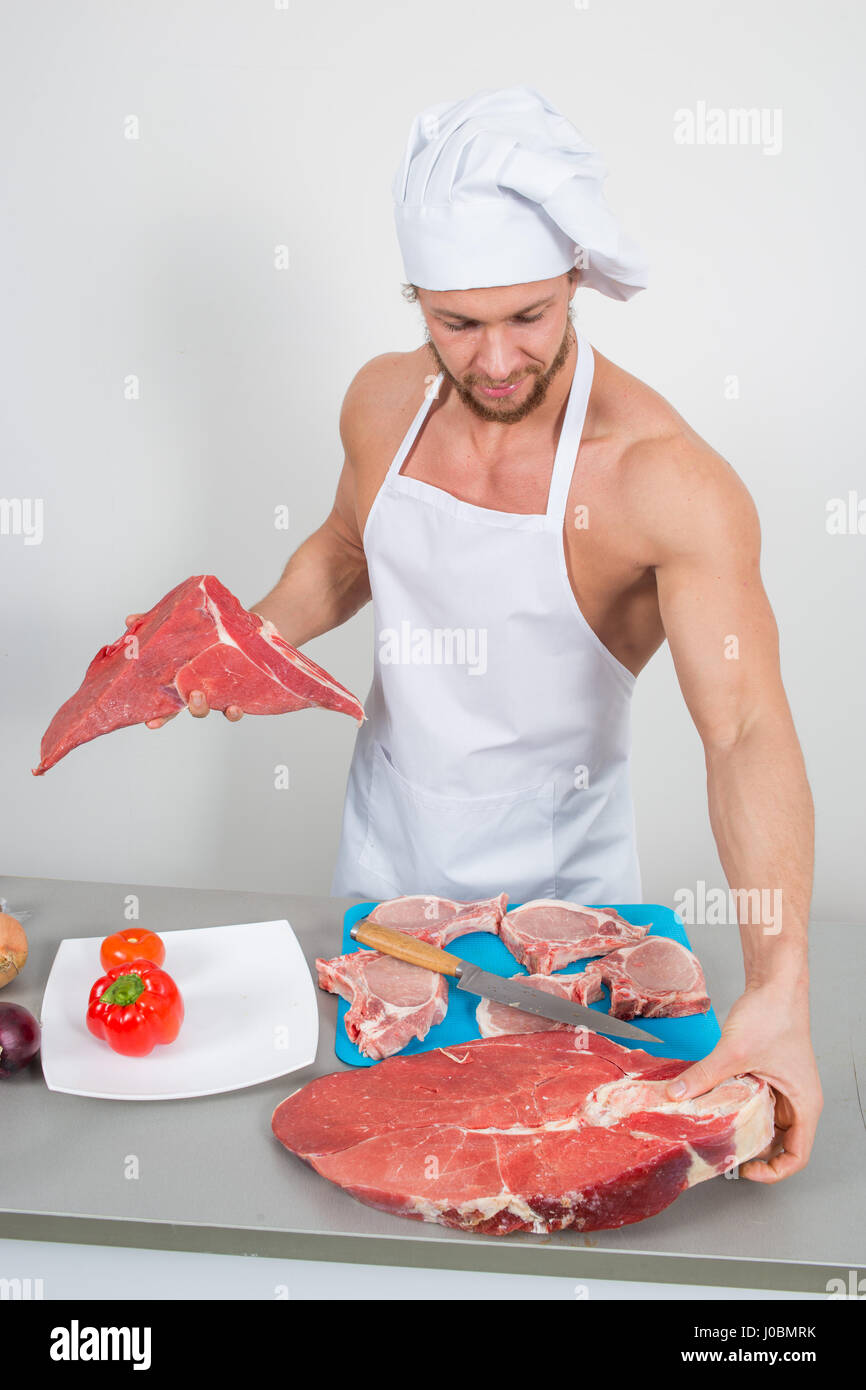 chef bodybuilder preparing large chunks of raw meat. natural proteins ...