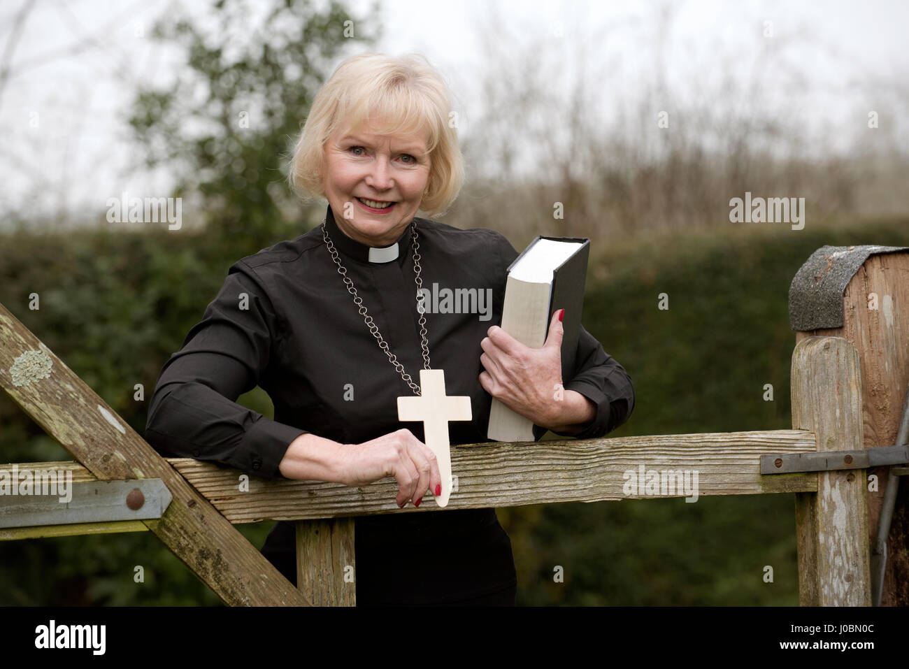 Elderly woman vicar making a house call in her parish in the English ...