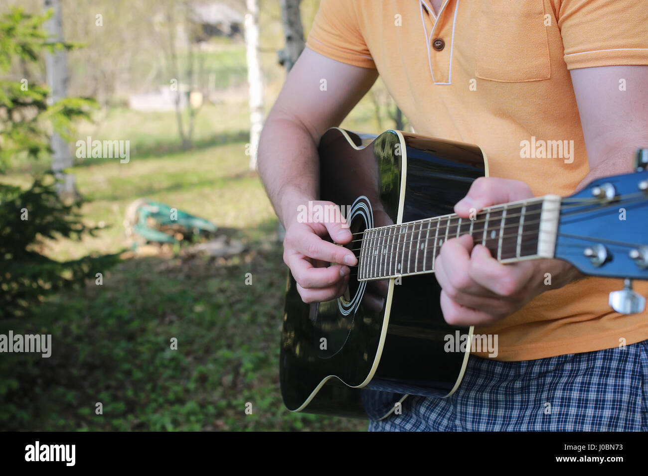 guitar string man hand outdoor Stock Photo - Alamy
