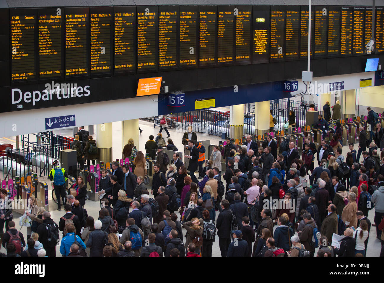 Commuters waiting to board platforms at Waterloo station, central ...
