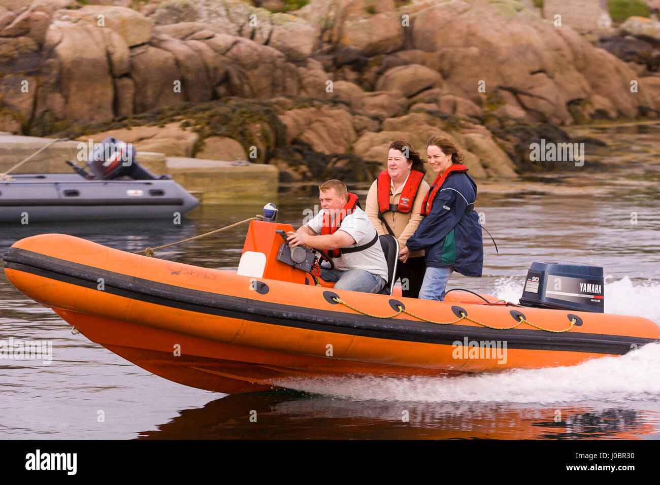 BURTONPORT, DONEGAL, IRELAND - People ride in small boat Stock Photo ...