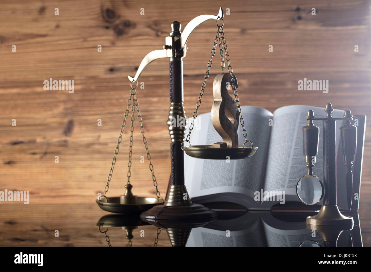 Law and justice concept. Scale of justice and legal code on wooden ...