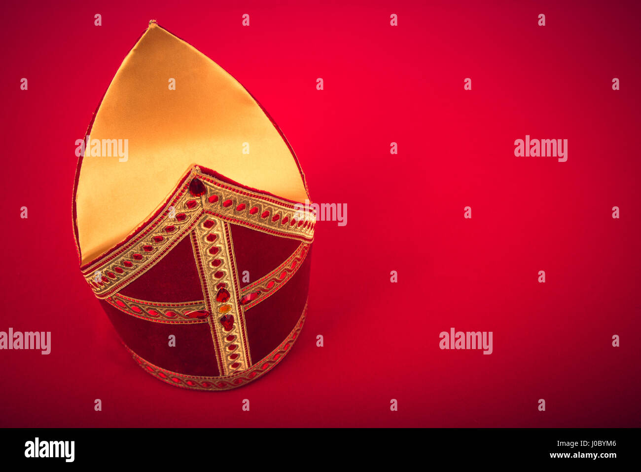 Mitre or mijter of Sinterklaas. On red background with copy space and ...