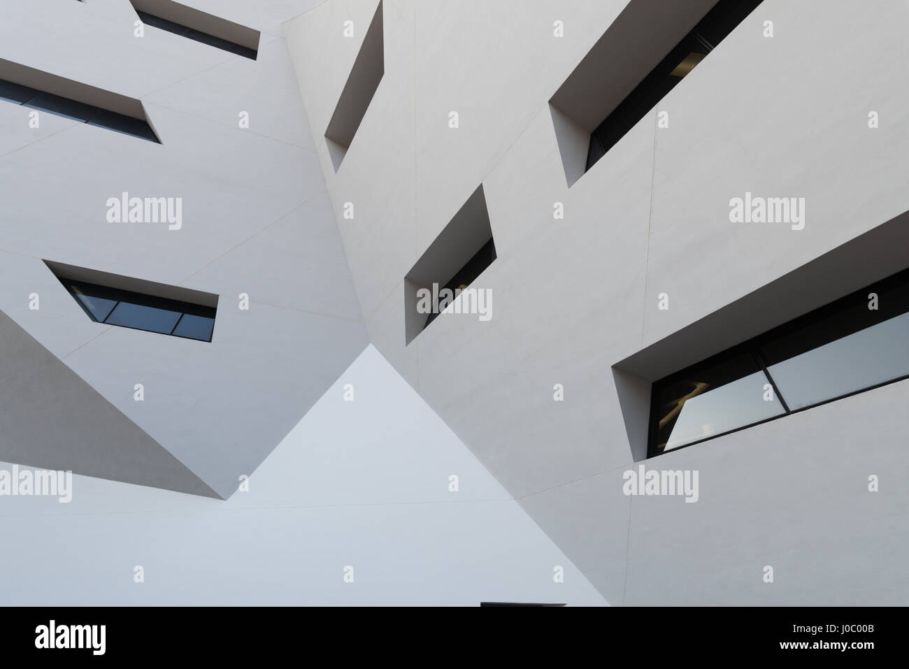 Abstract white building exterior with some windows Stock Photo - Alamy