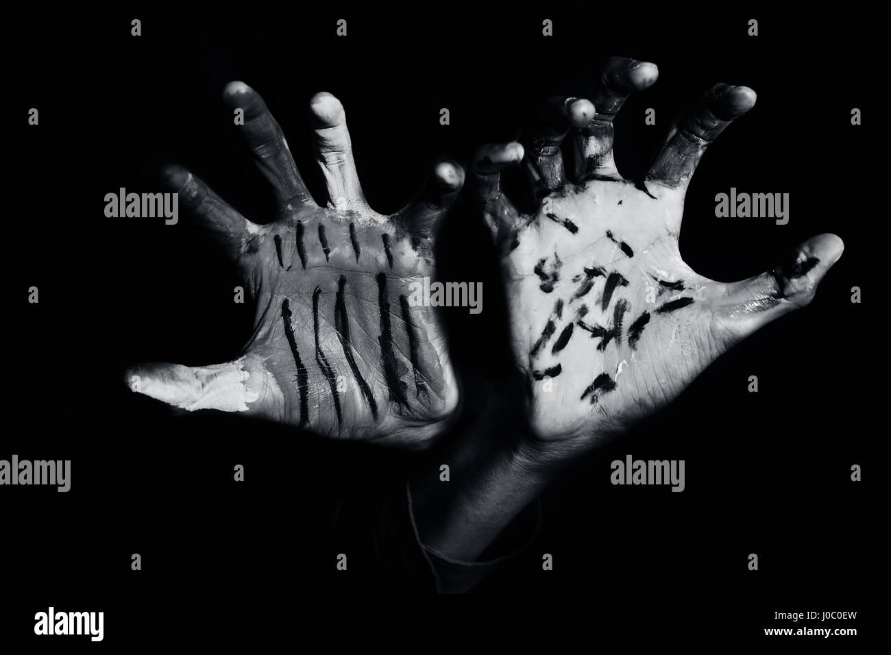 Two human aggressive painted hands in black Stock Photo - Alamy