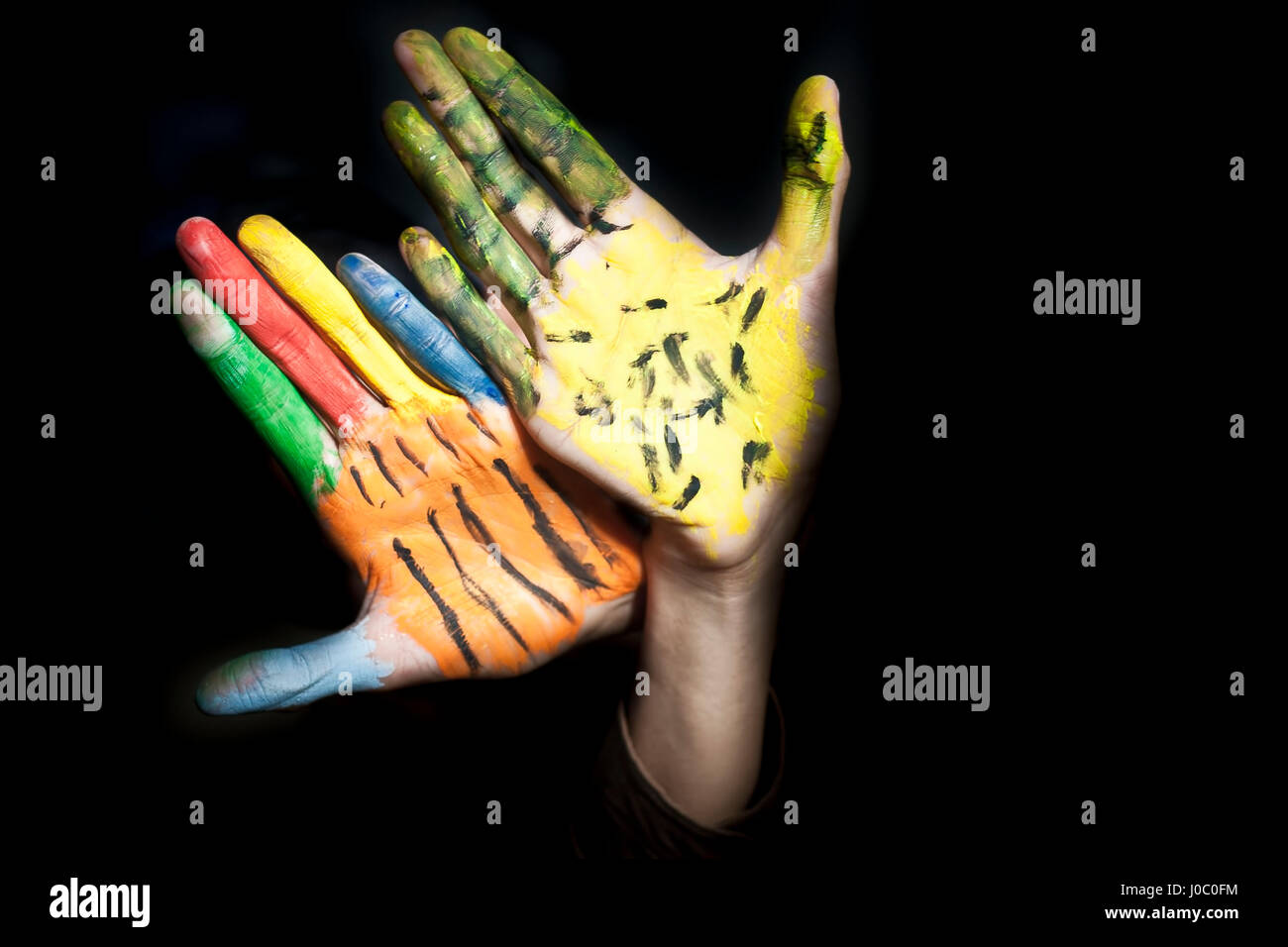 Yellow and Orange Painted hands Stock Photo - Alamy