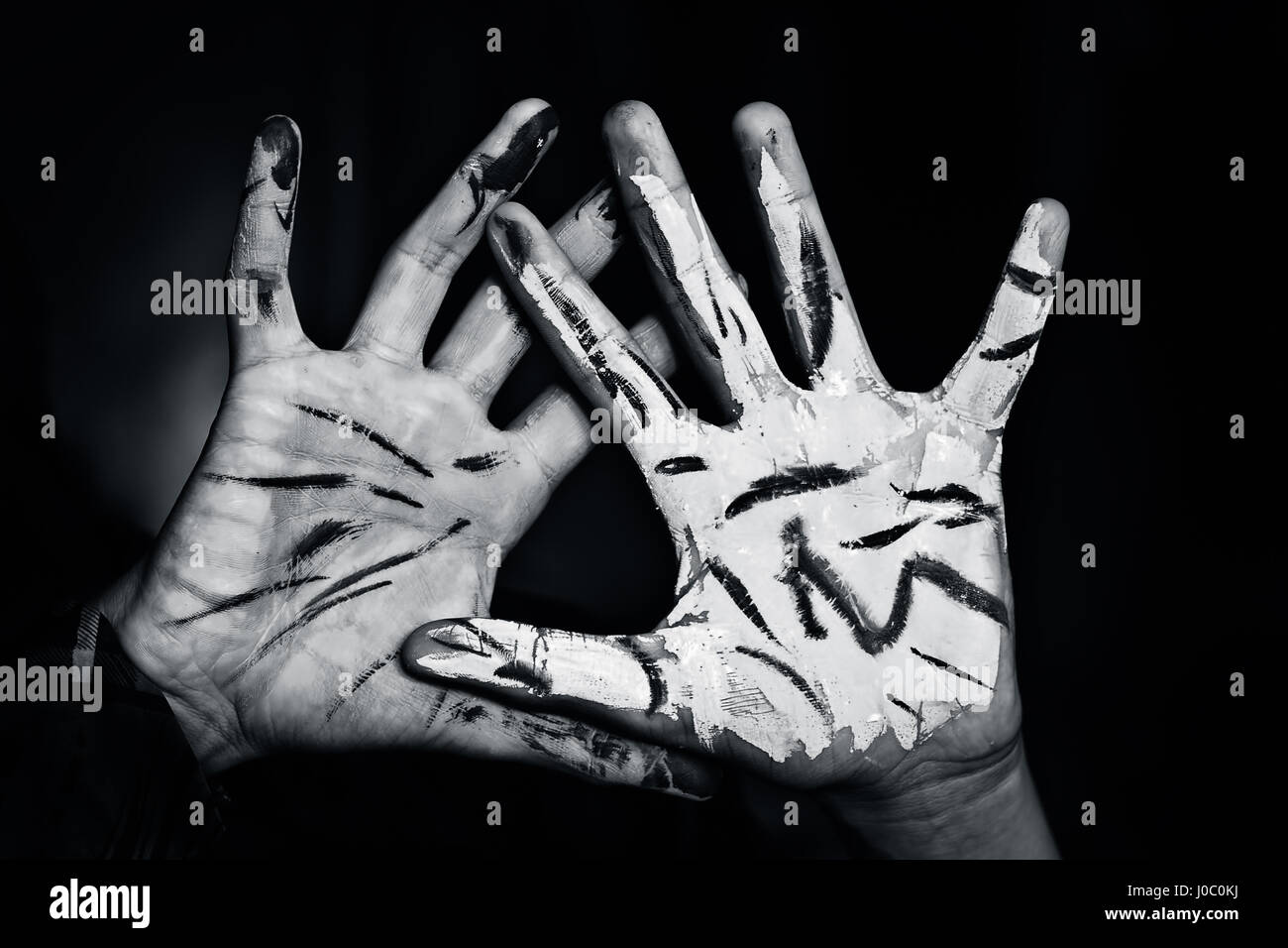 Two human aggressive painted hands Stock Photo - Alamy