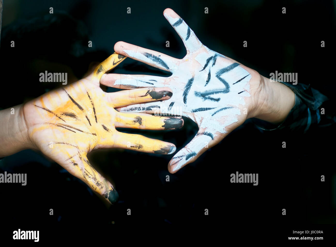 two painted hands Stock Photo - Alamy