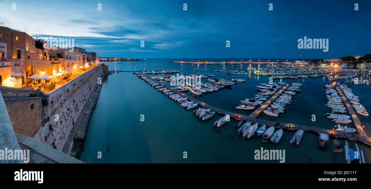 Dusk lights the harbor and the medieval old town of Otranto, Province ...