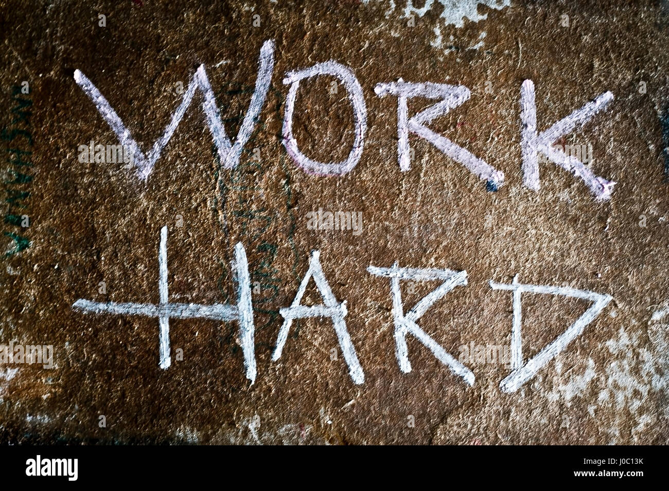 Work hard text written on a brown surface Stock Photo - Alamy