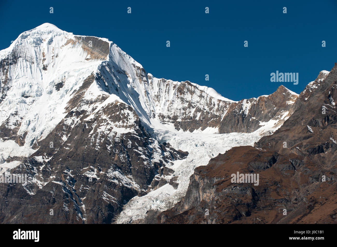 The looming face of Jomolhari, third highest mountain in Bhutan, seen ...