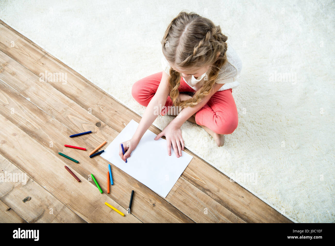 high angle view of little girl drawing picture Stock Photo - Alamy