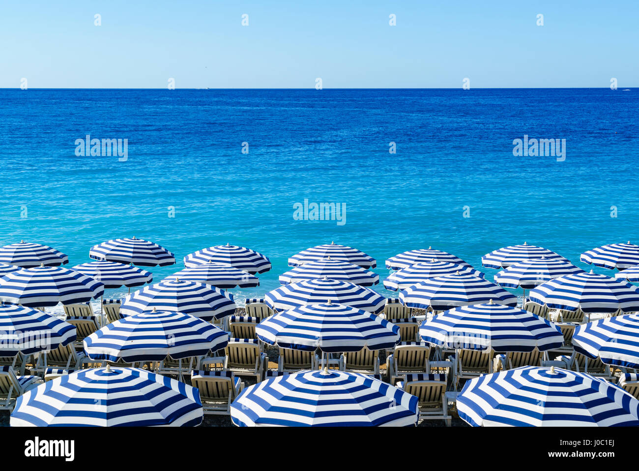 Blue and white beach parasols, Nice, Alpes Maritimes, Cote d'Azur ...