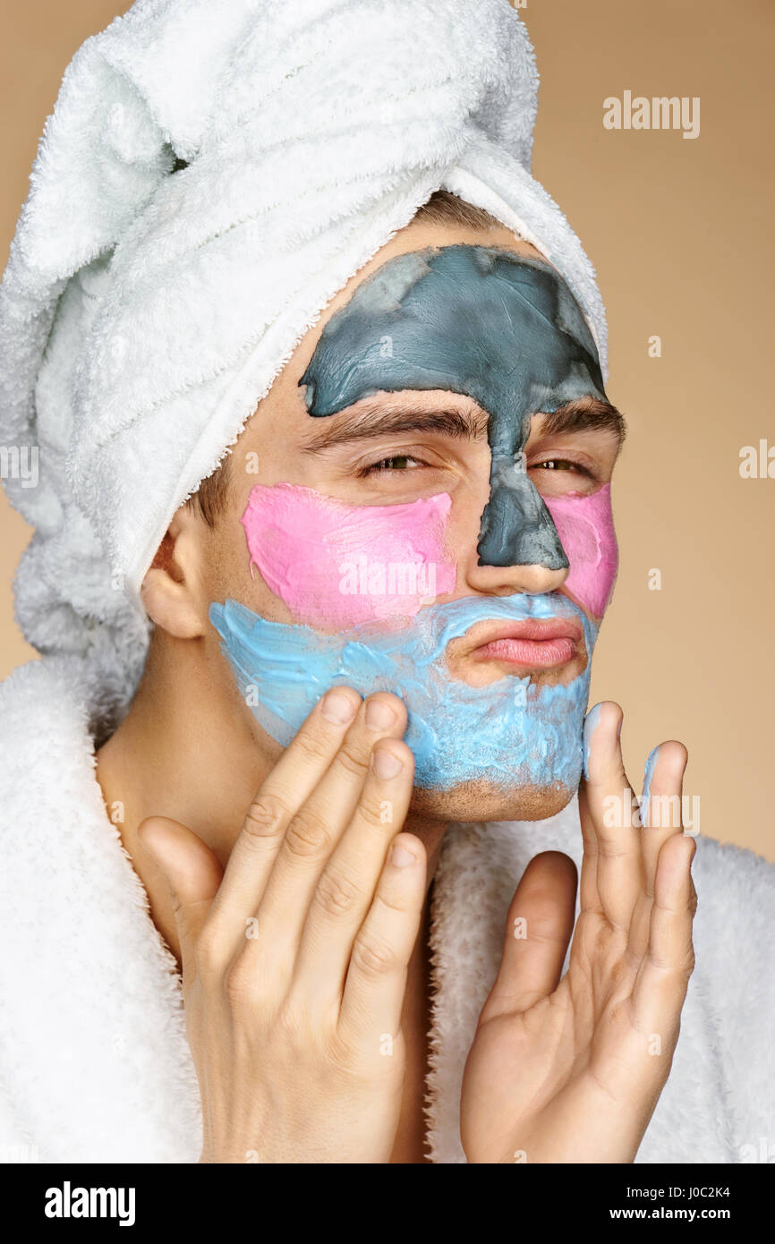 Man applying moisturizer to face. Photo of man in towel with different ...
