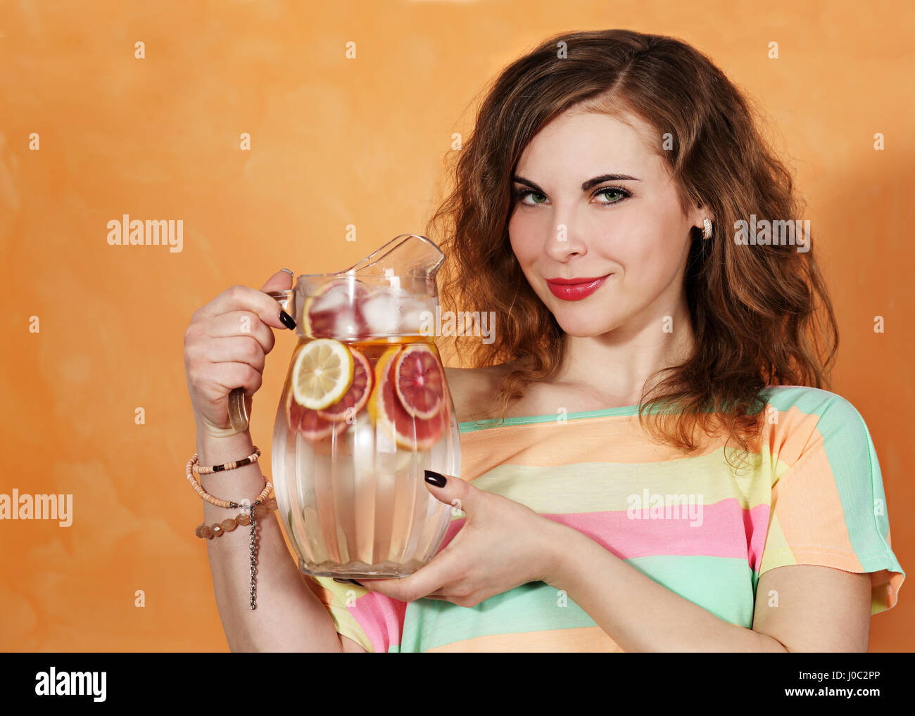 Woman with lemonade decanter Stock Photo - Alamy