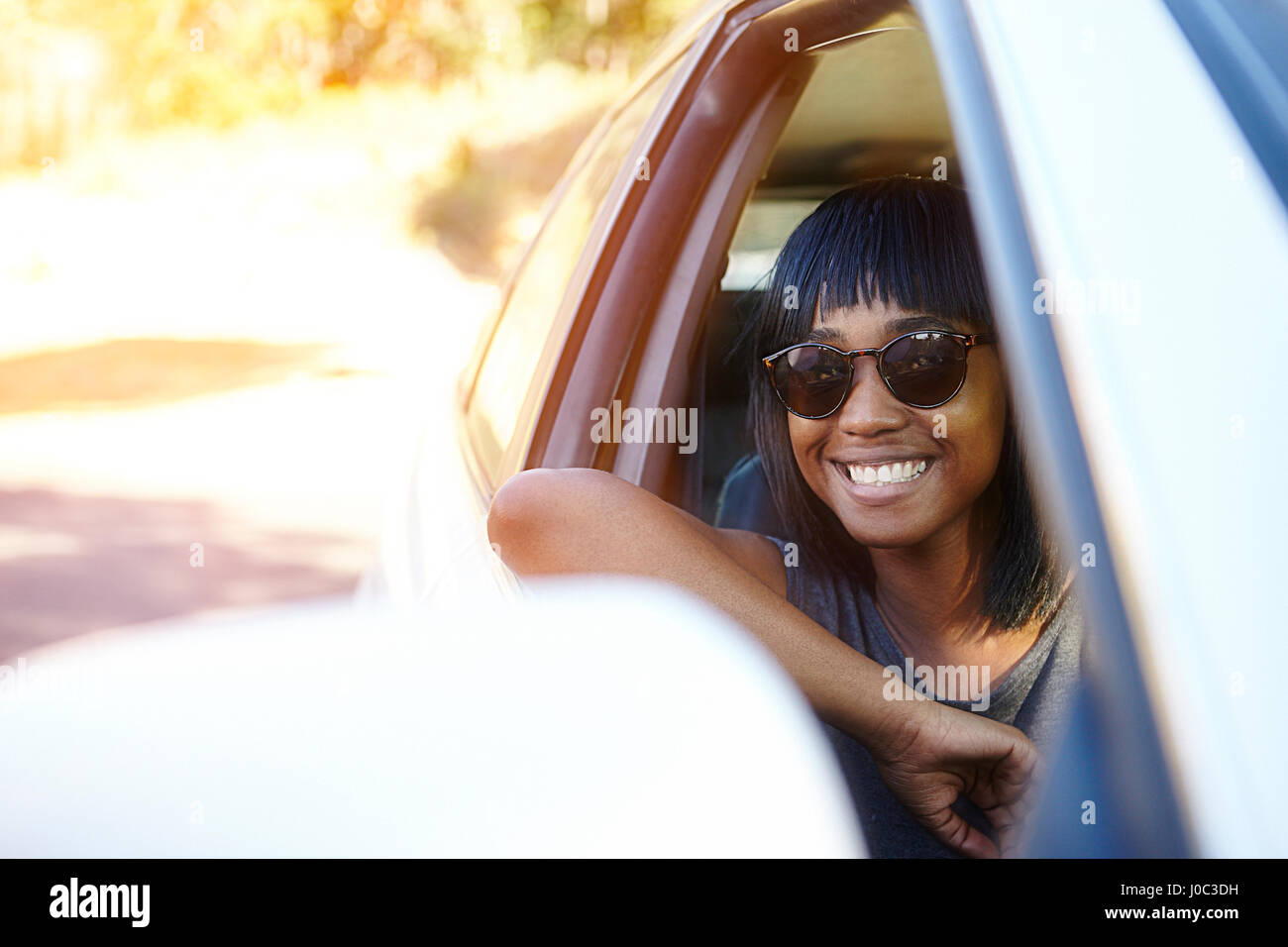 Portrait of young woman, looking out of car window Stock Photo - Alamy