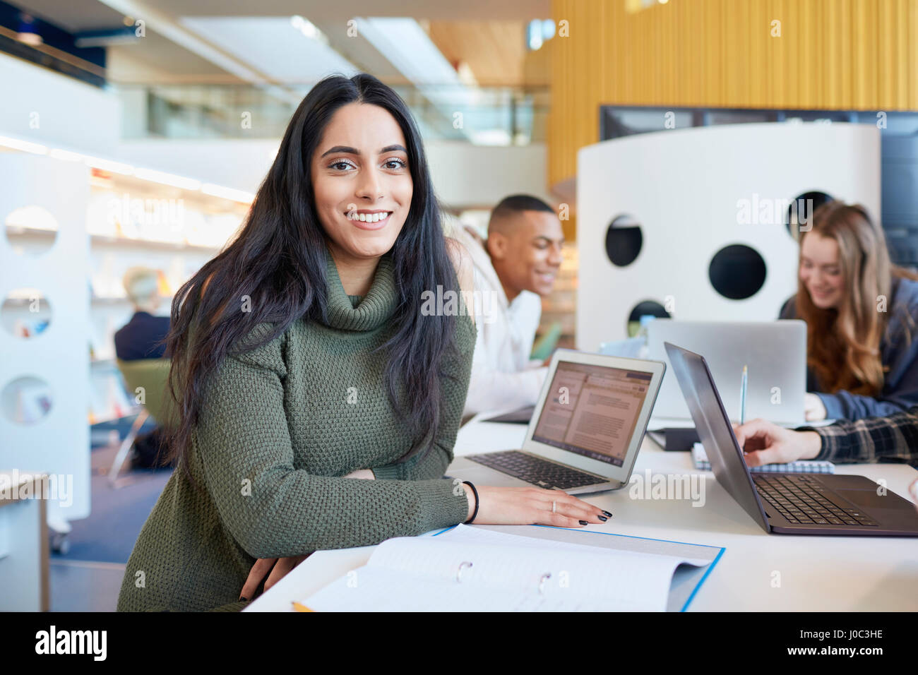 University students using laptops and digital tablet, working together ...