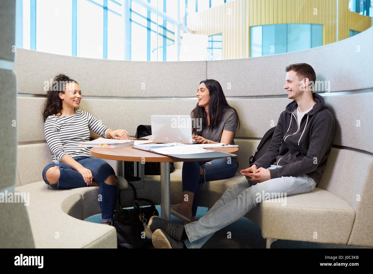 University students relaxing in modern seating area Stock Photo - Alamy