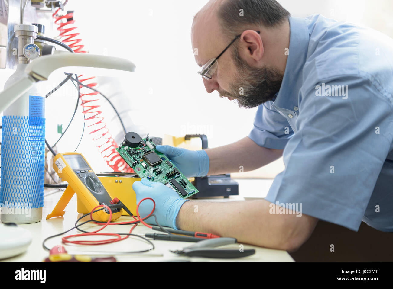 Worker testing electrical components in laboratory Stock Photo - Alamy